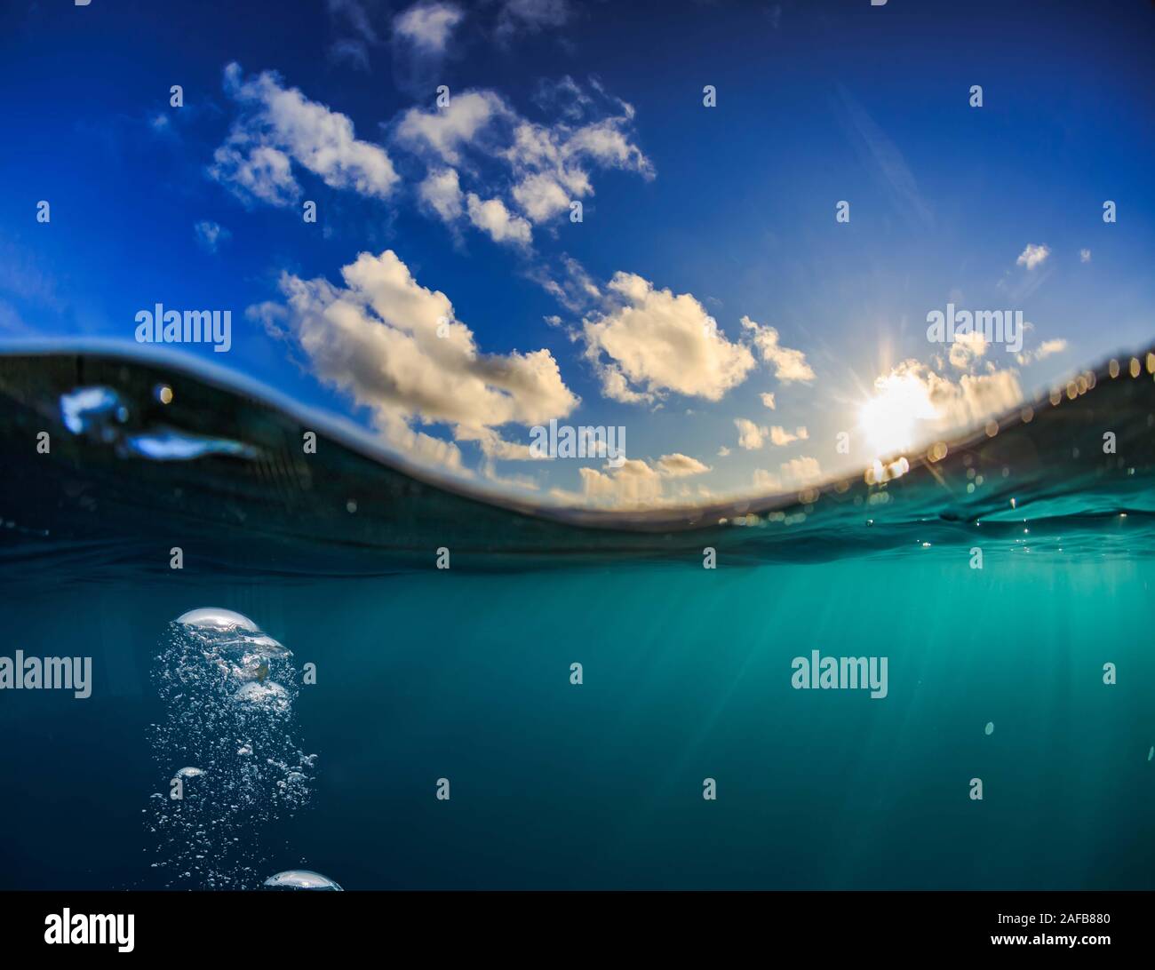 ocean wave falling down under sunset in lombok Stock Photo - Alamy