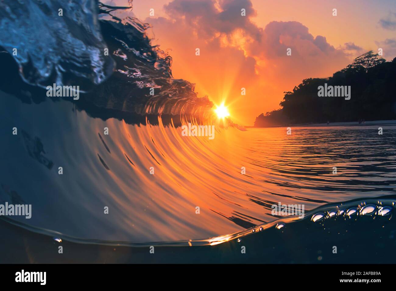 ocean wave falling down under sunset in lombok Stock Photo - Alamy