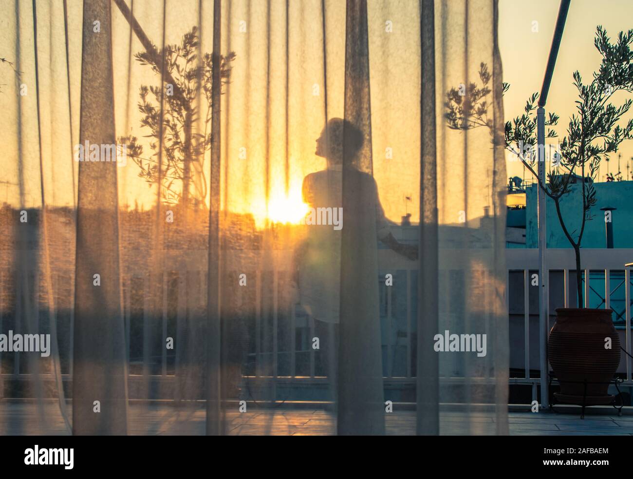 Young woman on the balcony hi-res stock photography and images - Alamy