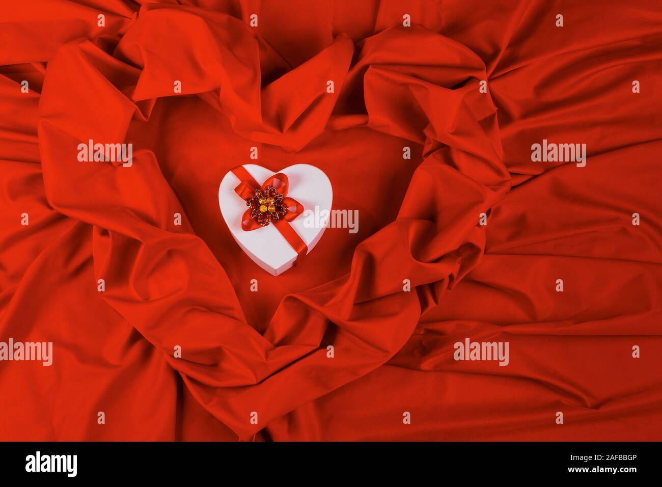 valentines greeting card. white cardboard box in shape of heart wrapped ...