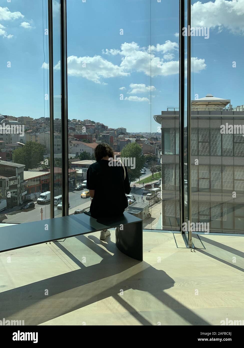 View of a woman sitting on a bench at newly opened contemporary art ...