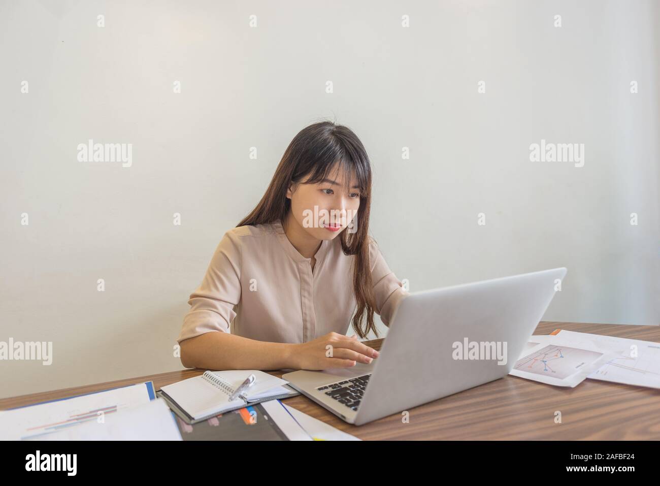 Woman employee using laptop for work Stock Photo - Alamy