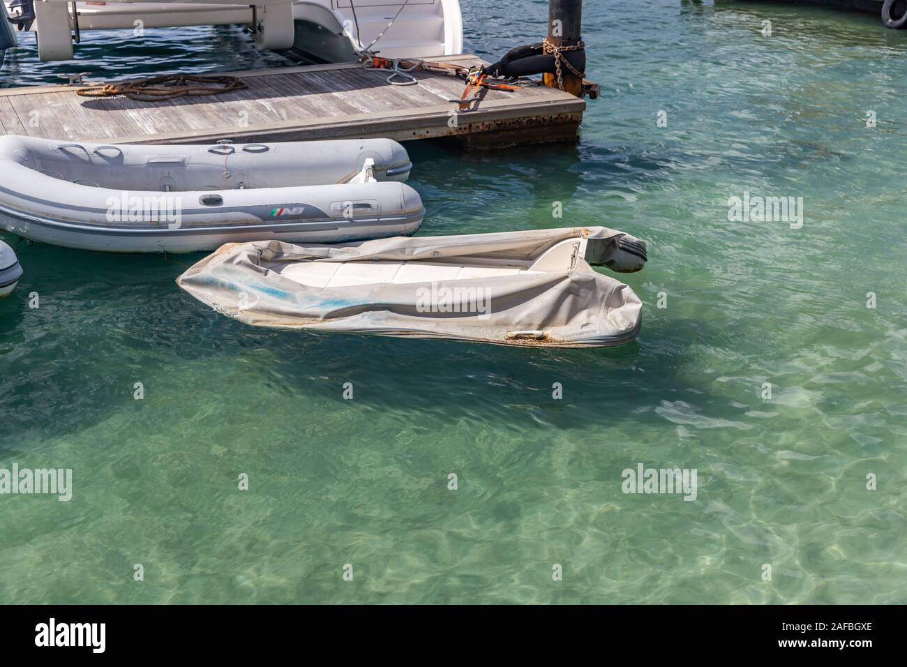 Deflated rubber dinghy in Blue Lagoon, Saint Vincent, Saint Vincent and ...