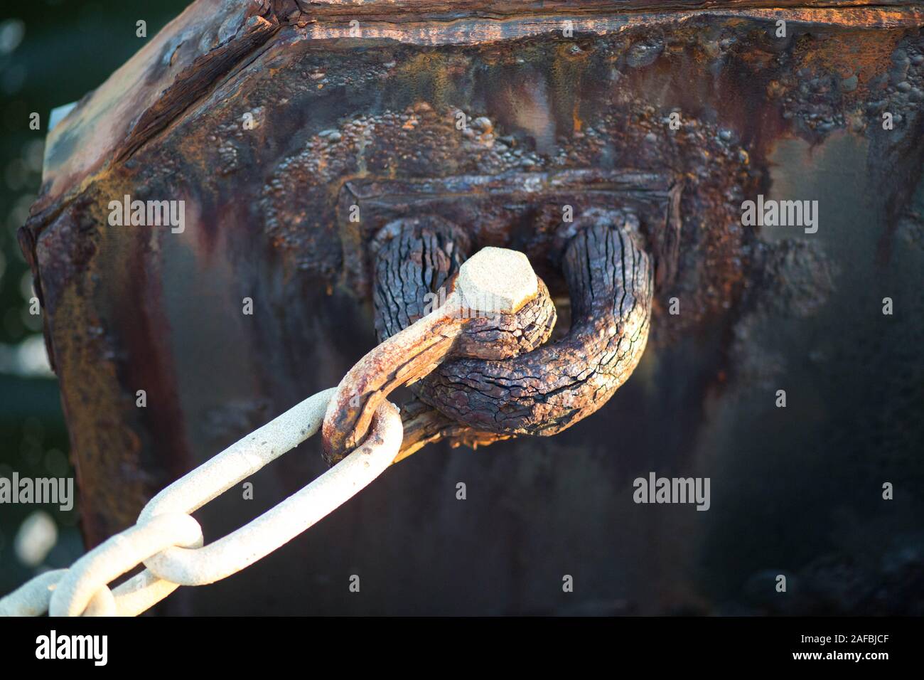 This is a photo of a corrded fixture near a boat dock. Corroded chain ...