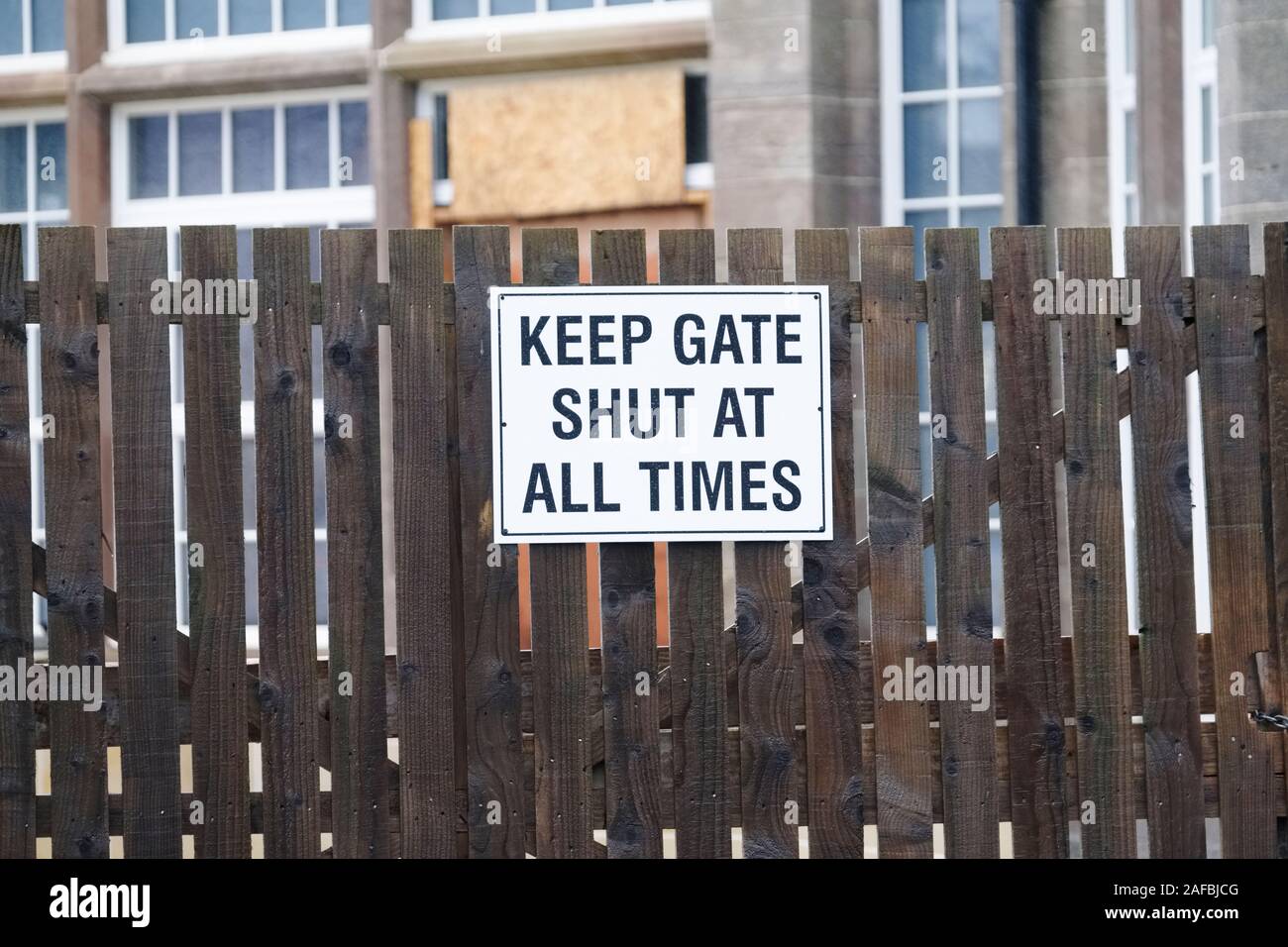 School gate to keep shut sign in grounds for security to children Stock ...