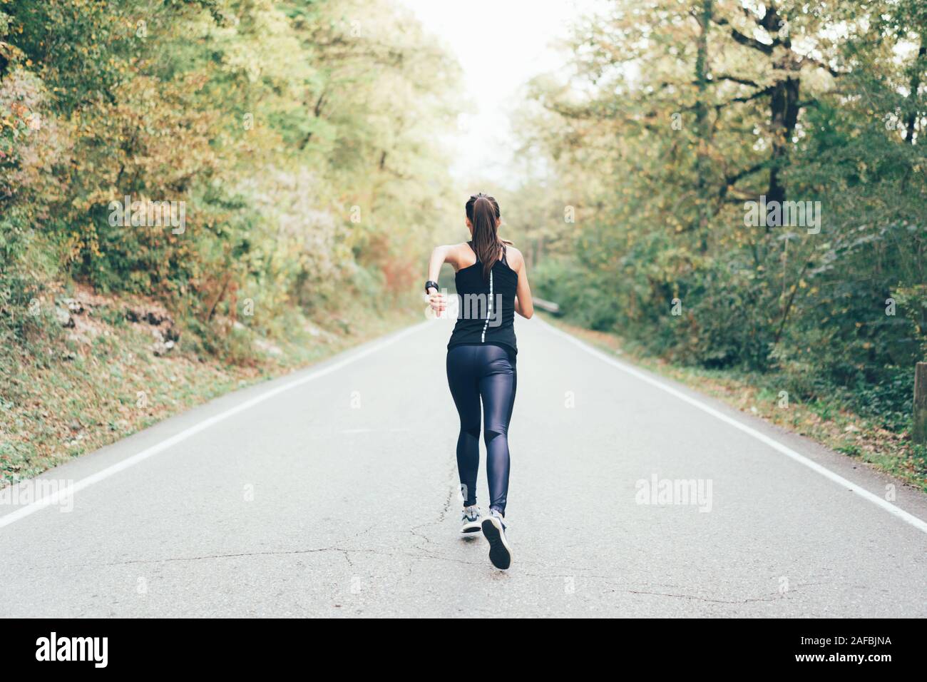 Back view woman jogging on hi-res stock photography and images - Alamy
