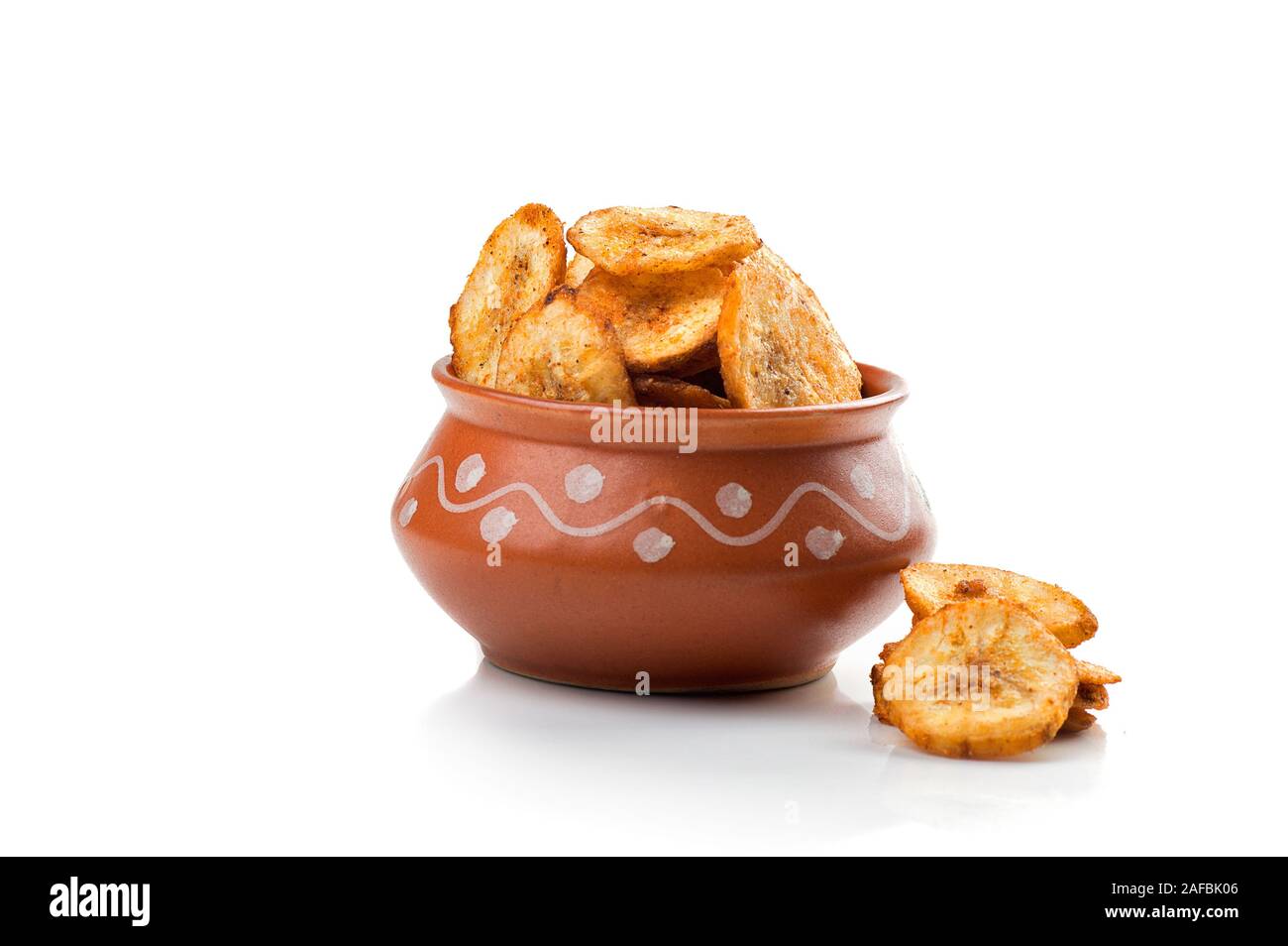 Banana chips on a white background Stock Photo - Alamy