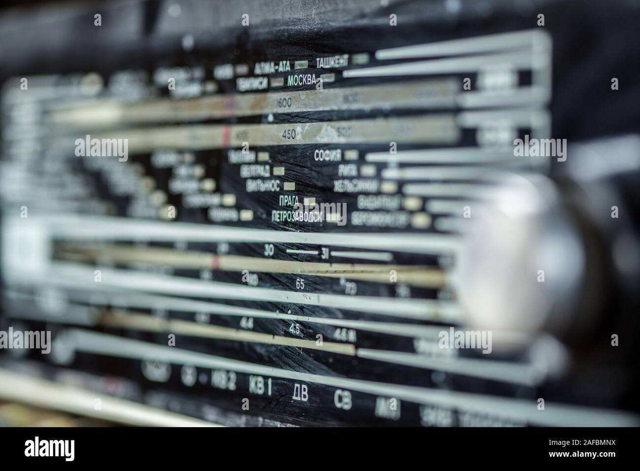 vintage radio tuning knob close-up . names of cities in the world in ...