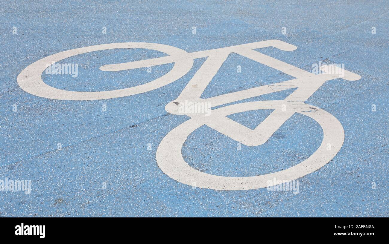 Bicycle lane road marking on blue painted asphalt Stock Photo - Alamy