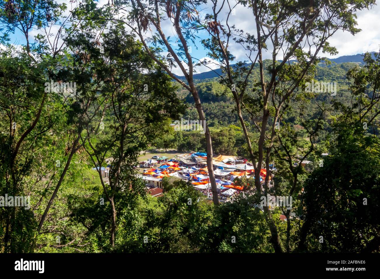 dramatic image of a Haitian market with colourful tents and tarps in ...