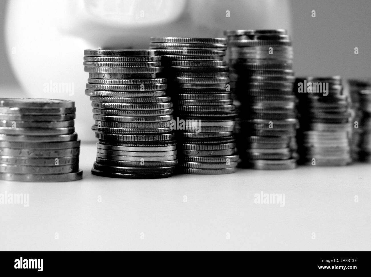 Stacks coins growing isolated on Black and White Stock Photos & Images ...