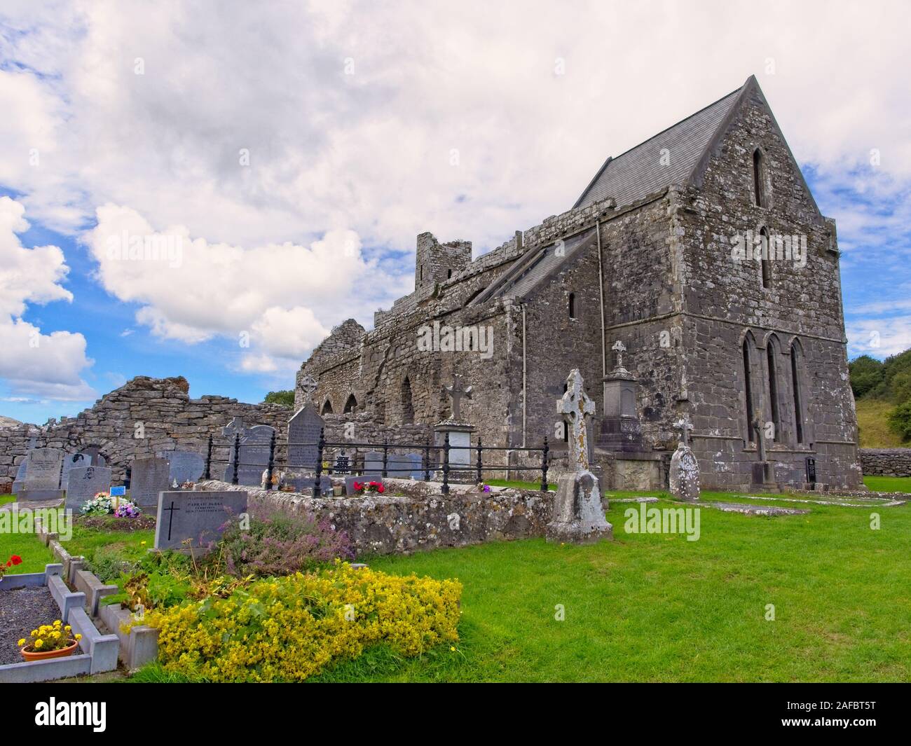 A view on the backside of Corcomroe Abbey and graves of the historic ...