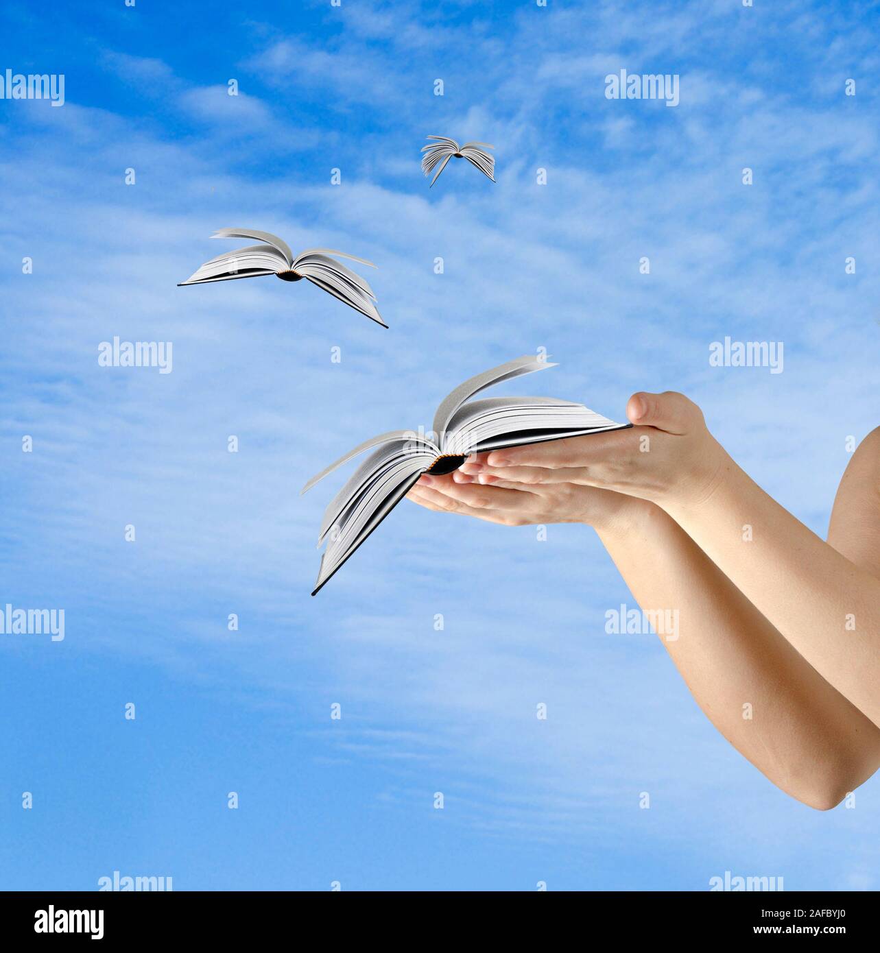 Books flying from hands Stock Photo - Alamy