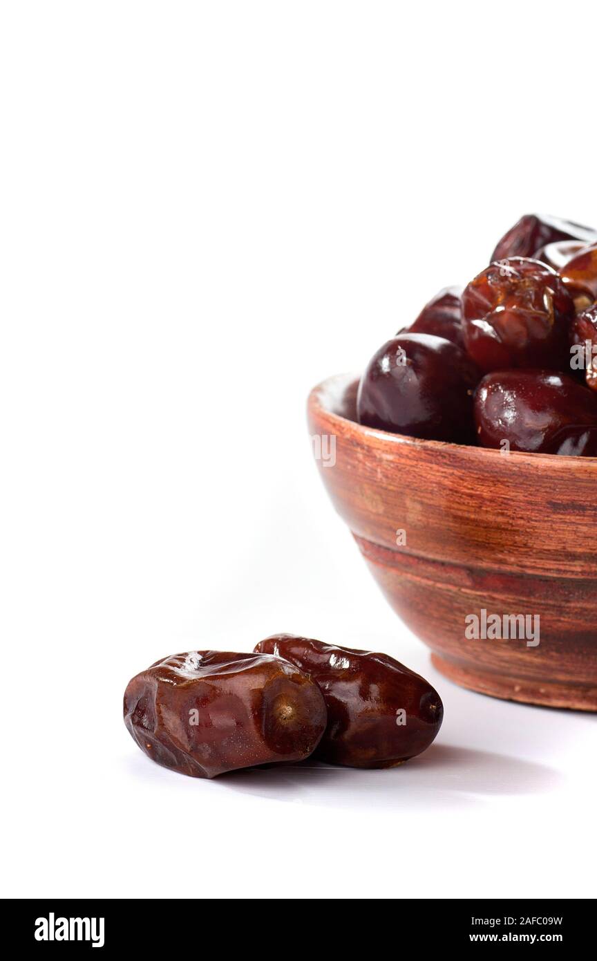 Dates in bowl on a white background. dried dates fruit Stock Photo - Alamy