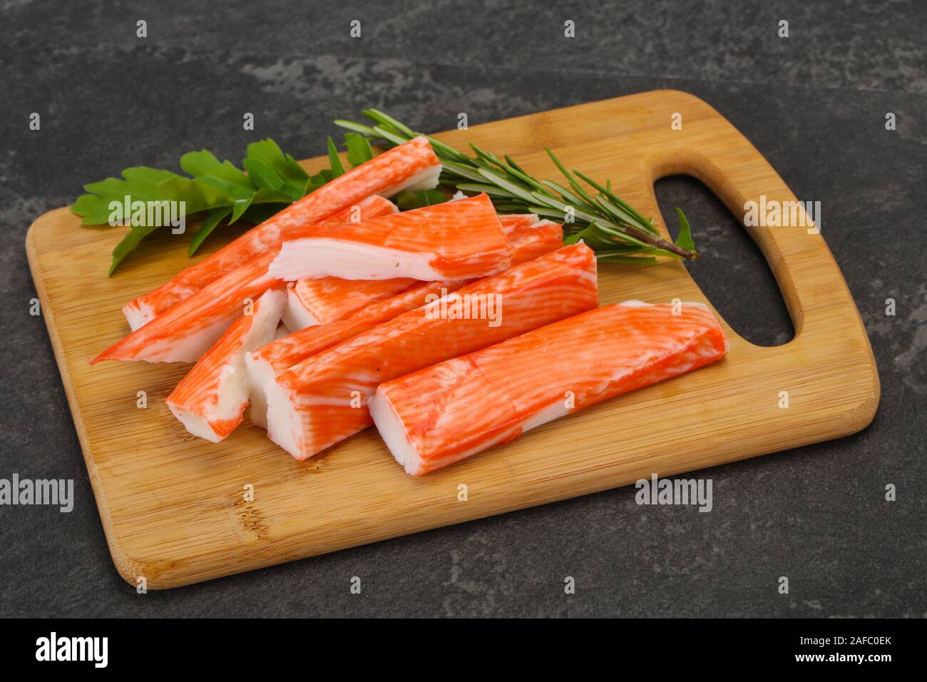 Crab stick surimi over wooden board Stock Photo - Alamy