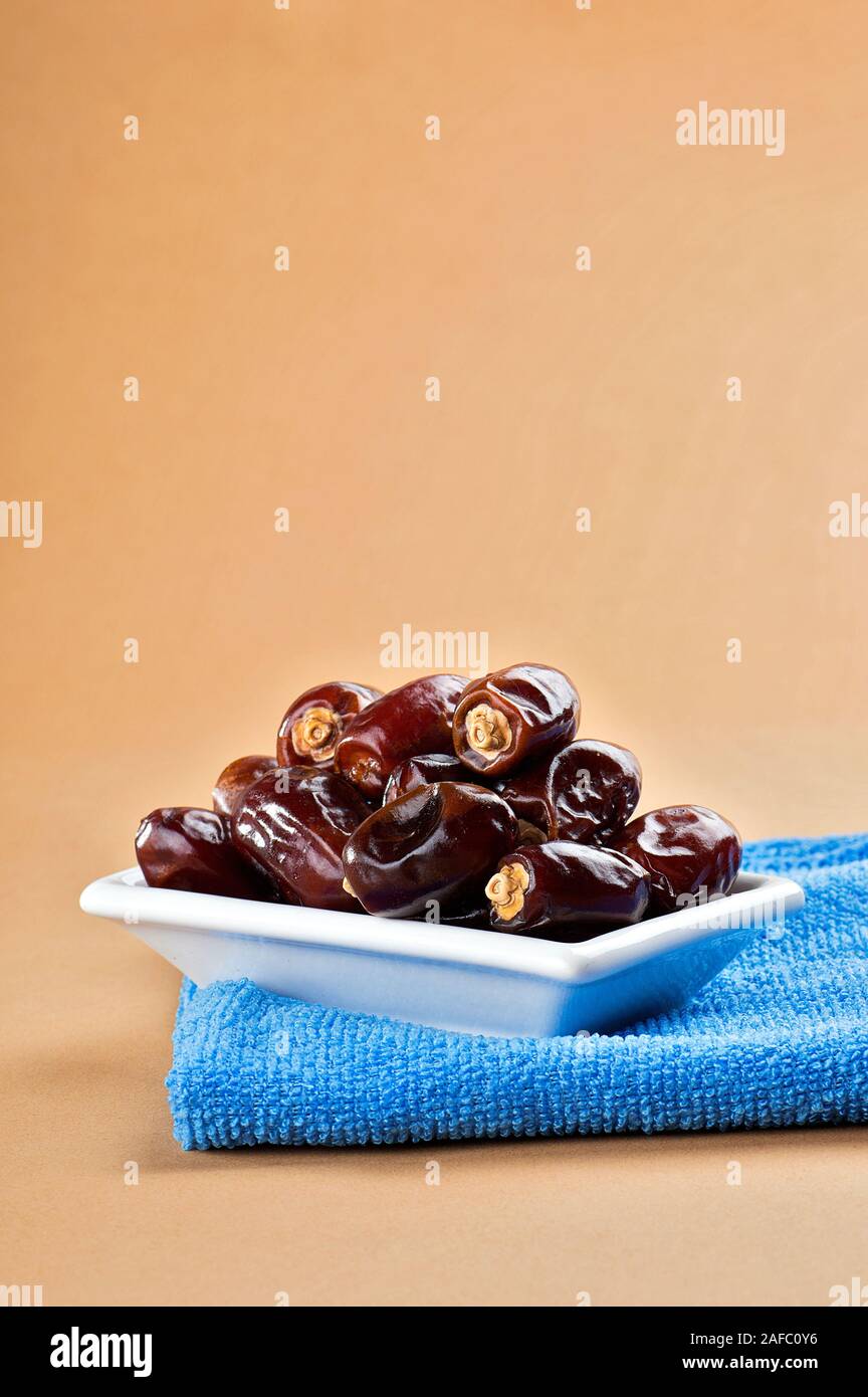 Dates in plate. Dried dates fruits Stock Photo - Alamy