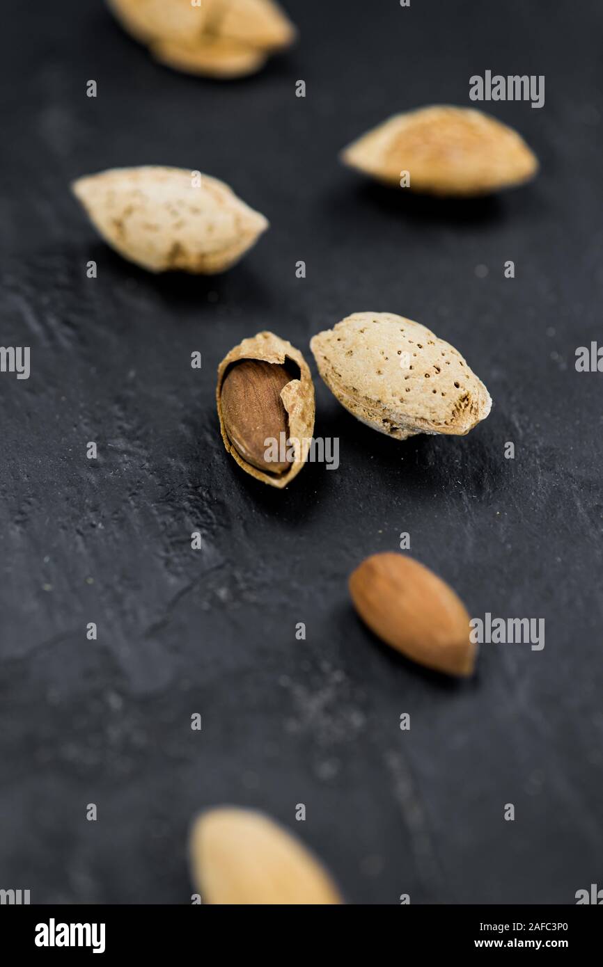 Dark slate slab with roasted and salted Almonds (in the shell Stock ...