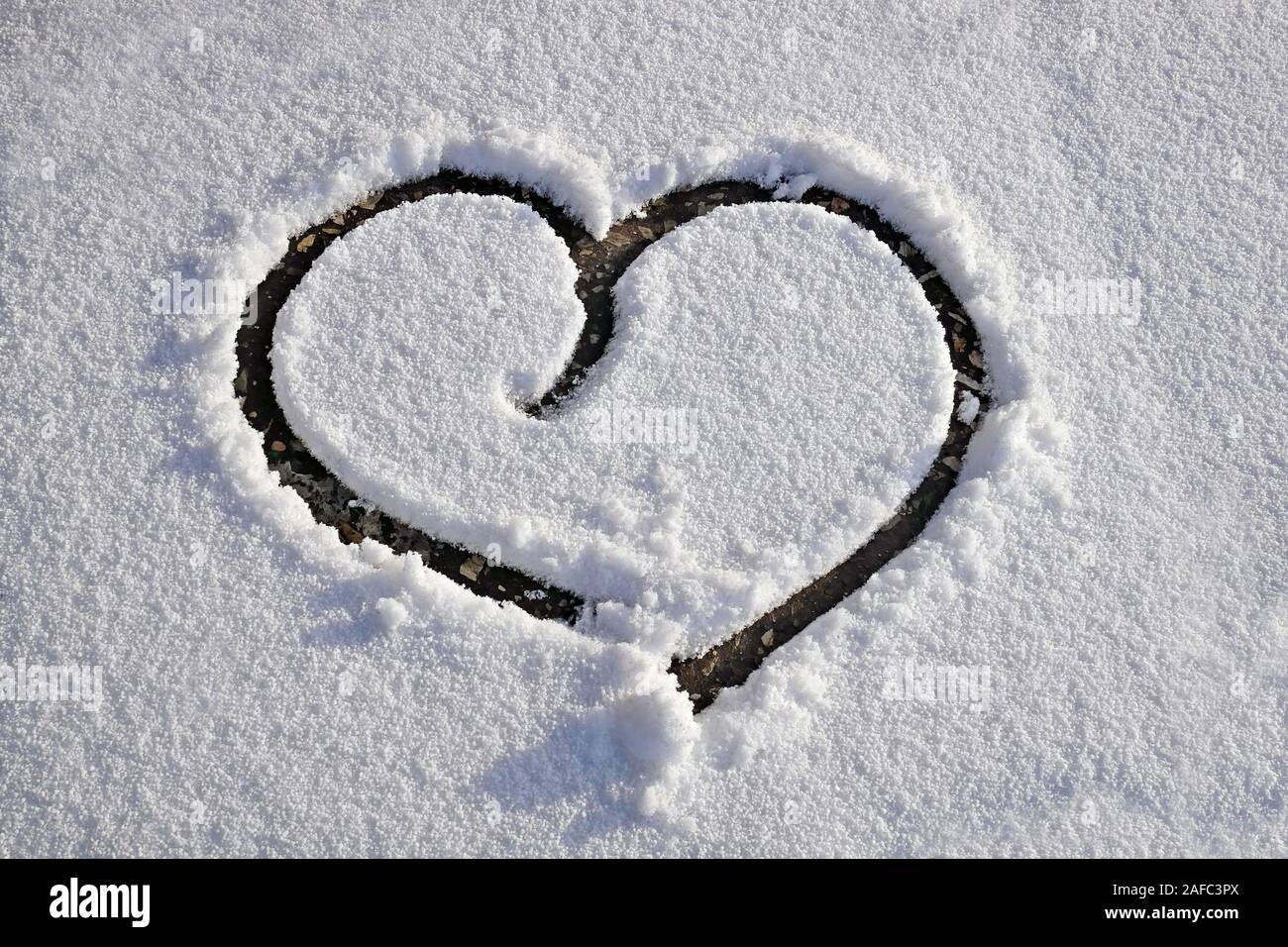 Sidewalk snow heart hi-res stock photography and images - Alamy