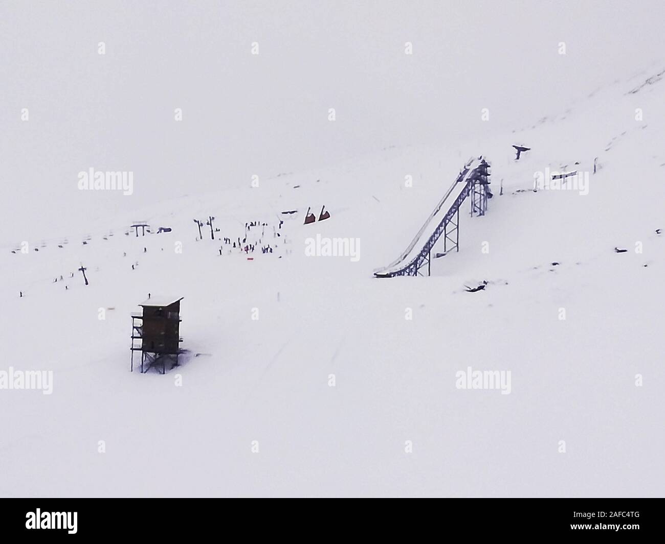 Ski jumping ramp at Astún ski resort on a foggy day with snowy ...