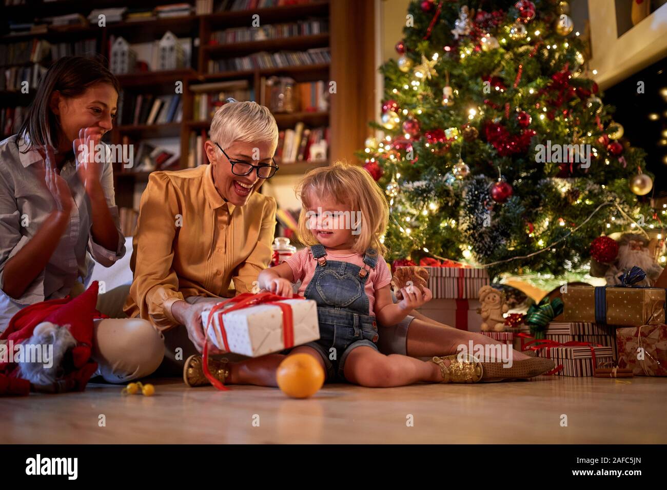 winter holidays and people concept – Family celebrating christmas at ...
