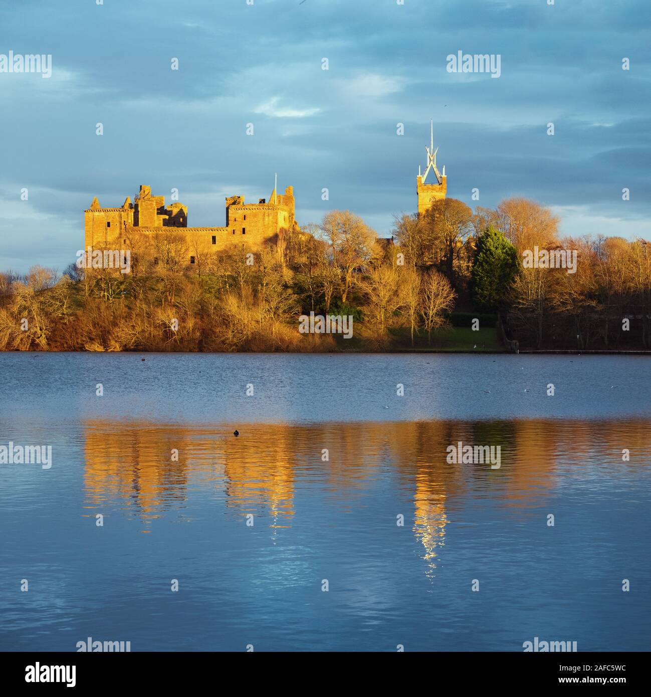 Medieval castle on the lake lit by the setting sun. Linlithgow Palace ...