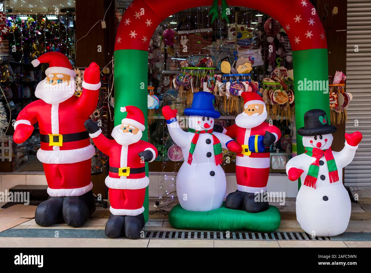 Snowman and Santa Claus toys standing in front of store Stock Photo - Alamy