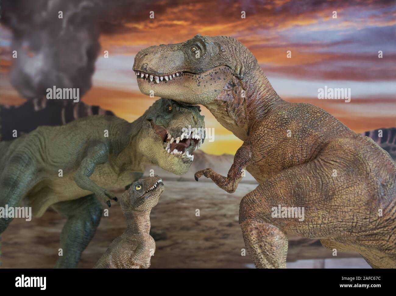 Family of Tyrannosaurus rex dinosaurs with erupting volcano in the ...