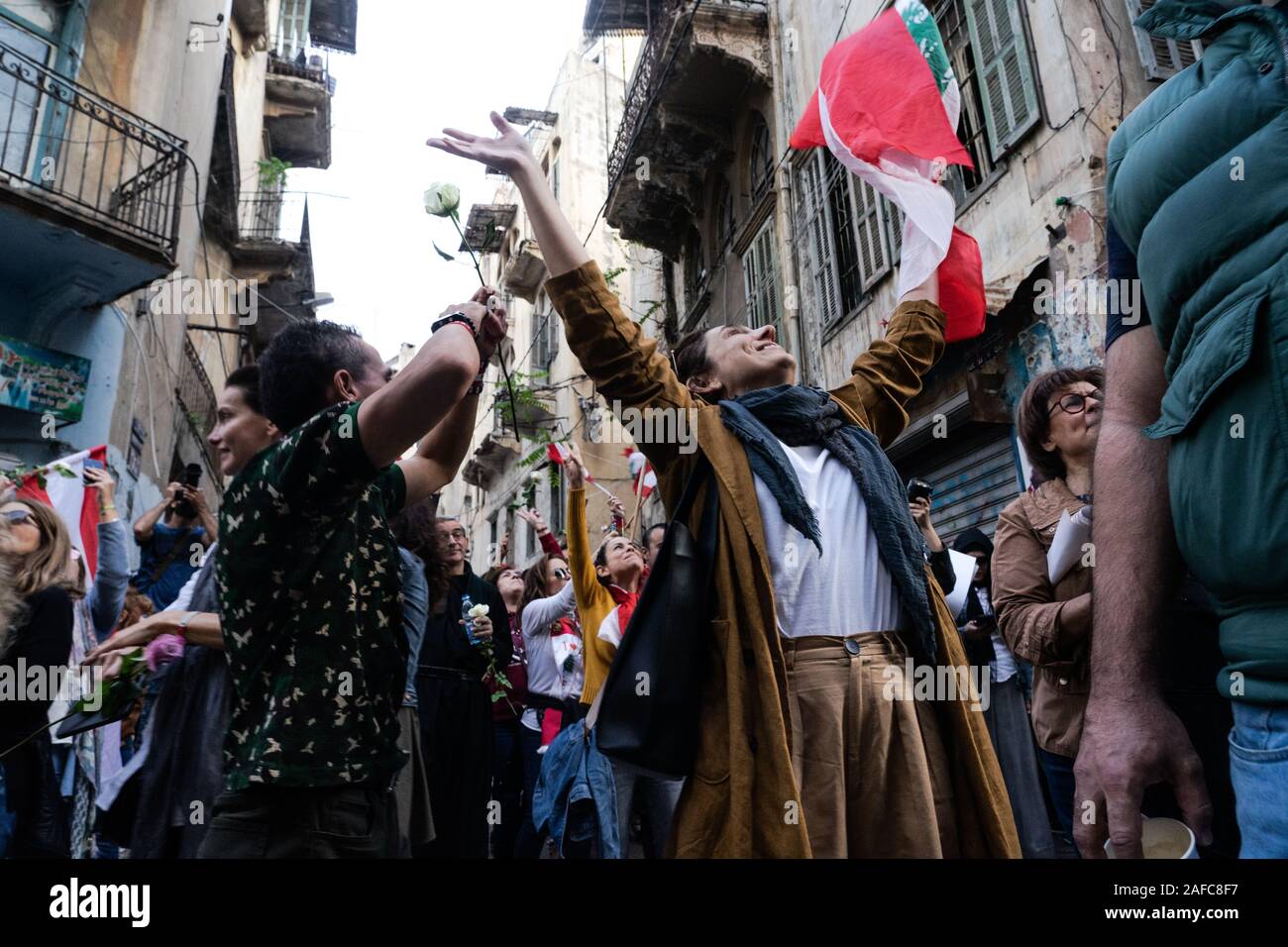 Demonstrators looking at balconies throwing rice during the march of ...