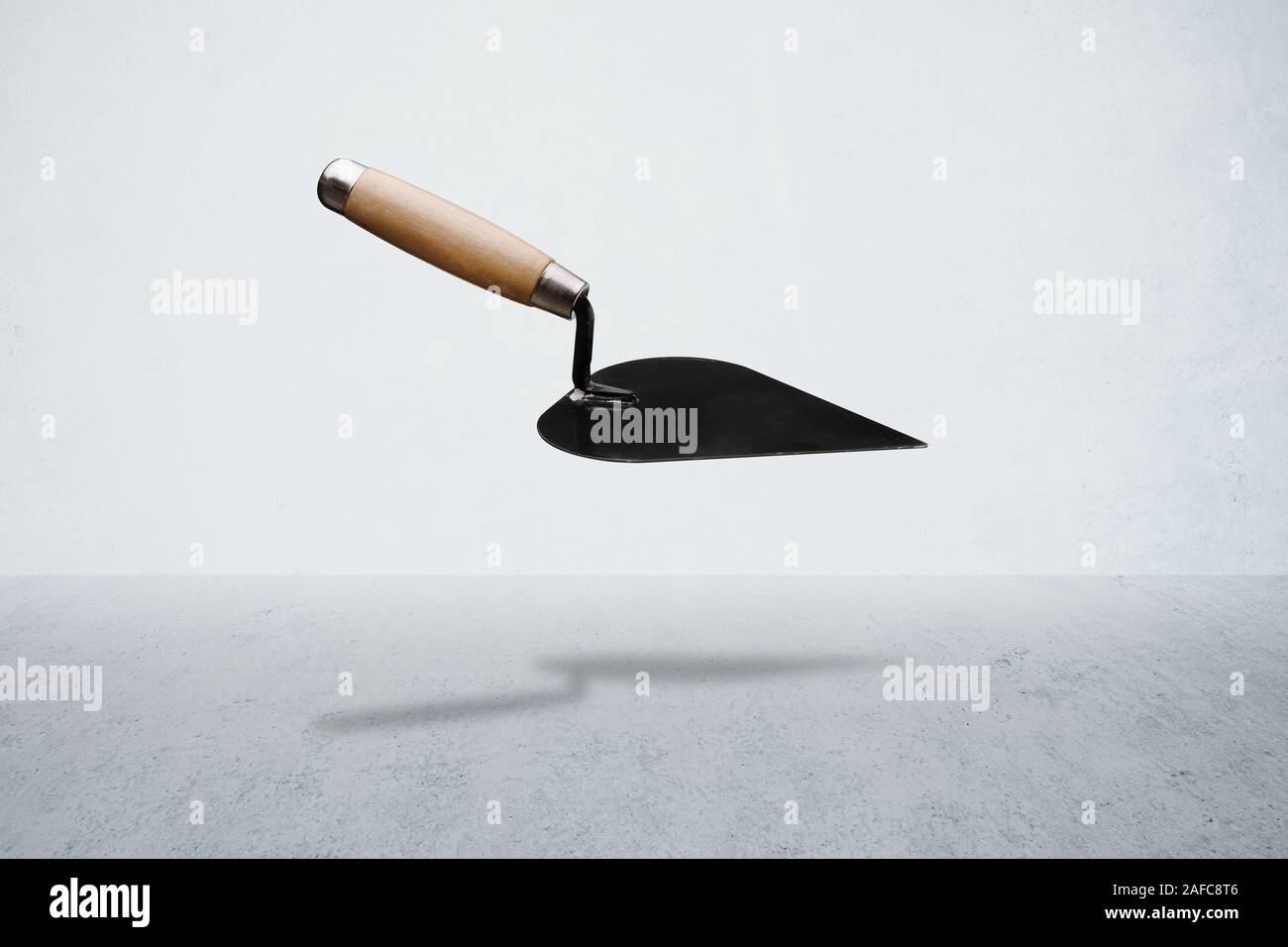 building trowel on concrete room background Stock Photo - Alamy