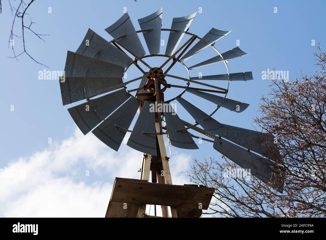 Old metal vintage windmill in trees Stock Photo - Alamy
