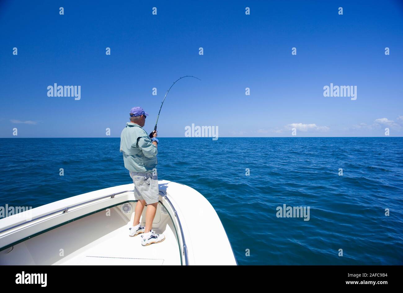 Man fishing off bow of boat in Florida, USA Model Released Photo Stock ...