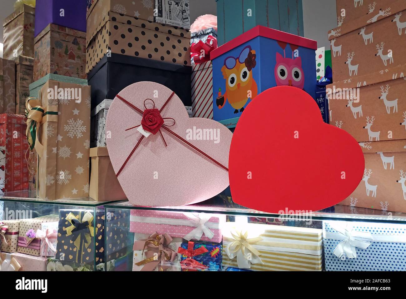 Multicolored gift boxes with bows in the mall. Paper boxes for ...