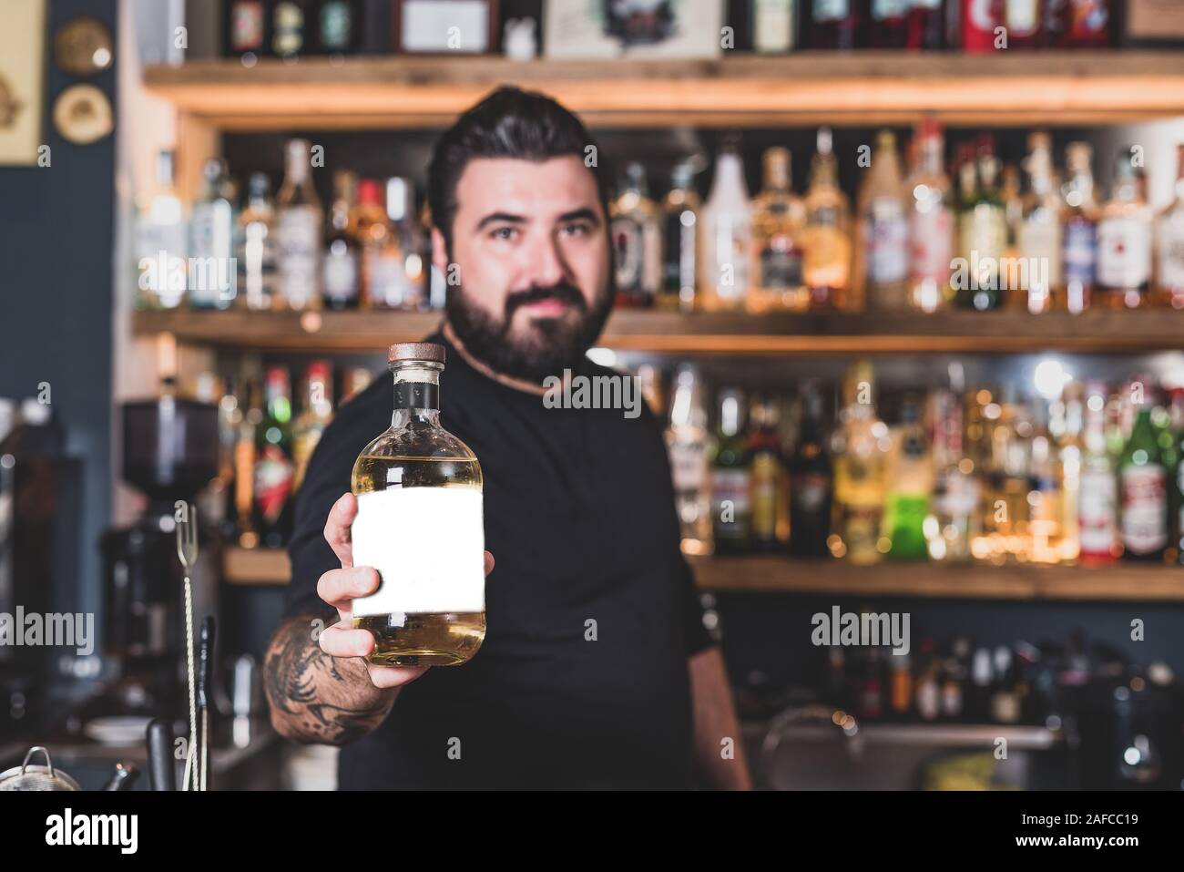 Hipster bartender offers to drink a soft drink, mock up on the label of ...