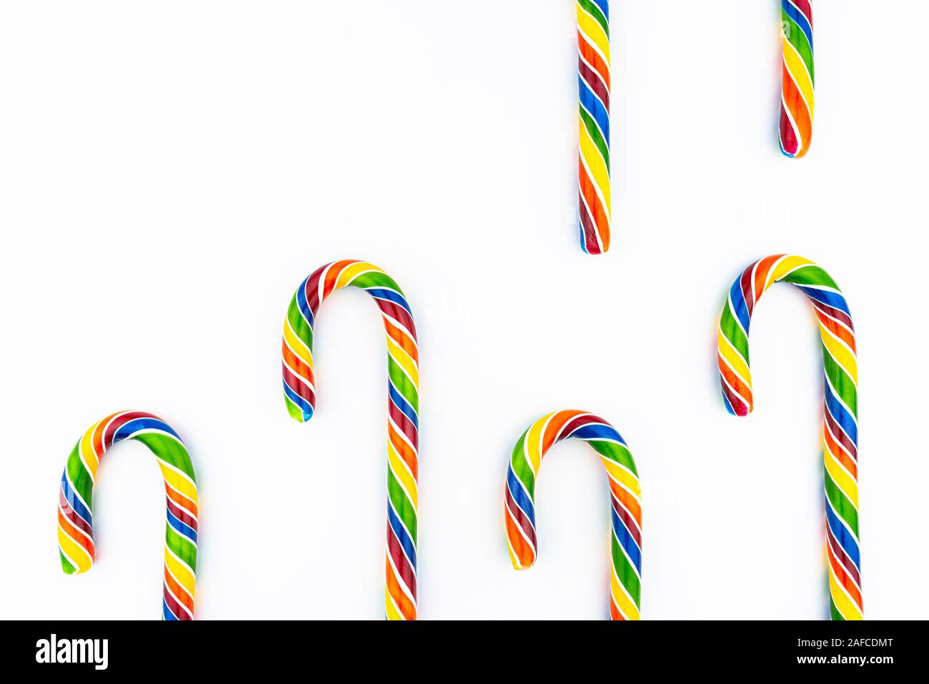 Background made of colorful candy canes, isolated on a white background ...