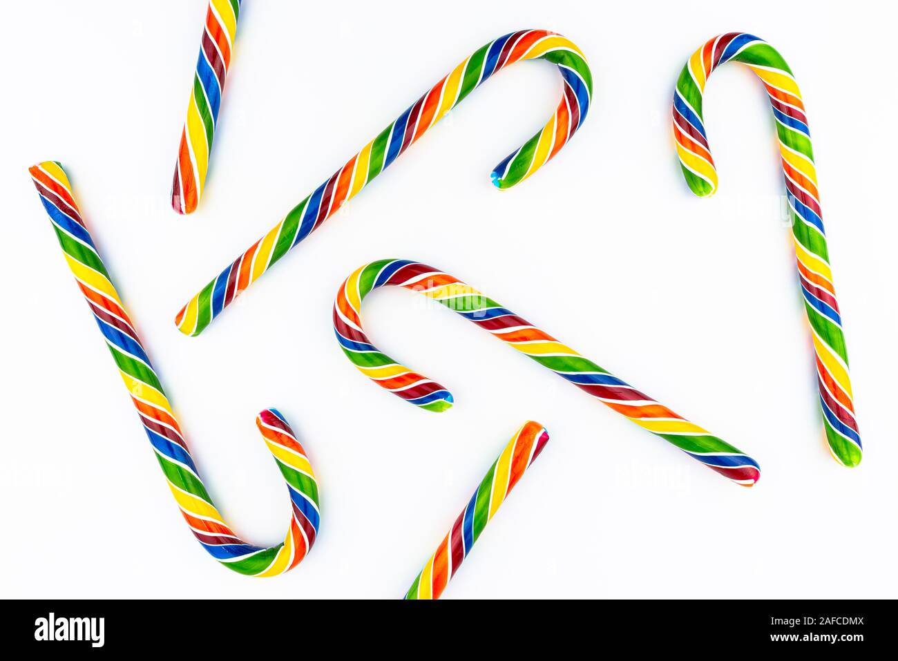 Background made of colorful candy canes, isolated on a white background ...