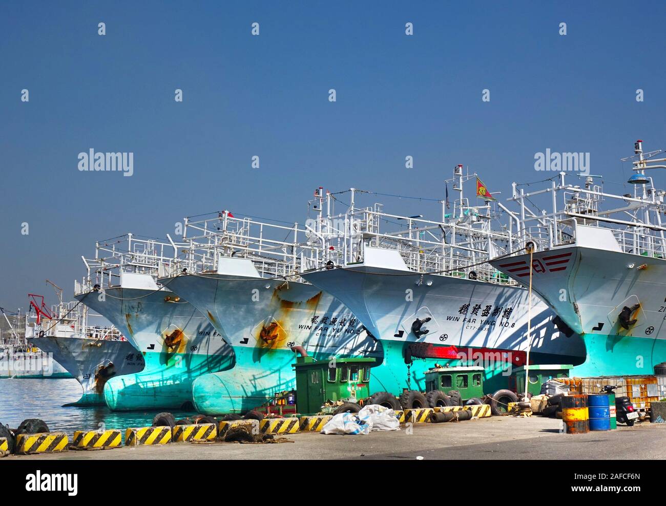 KAOHSIUNG, TAIWAN -- DECEMBER 1, 2019: A row of large ocean-going ...
