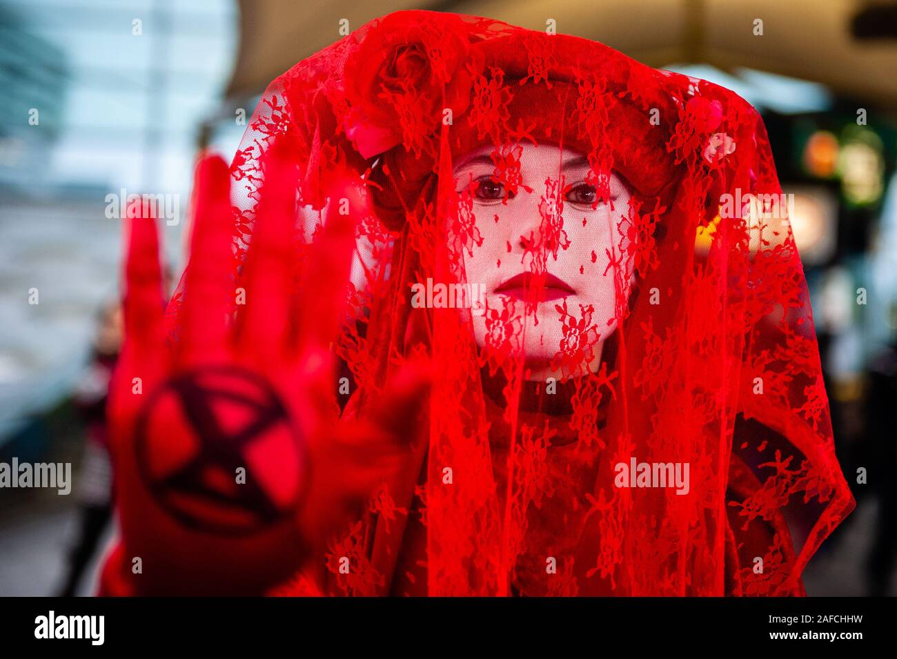 A red rebel activist shows off her hand with the Extinction rebellion ...