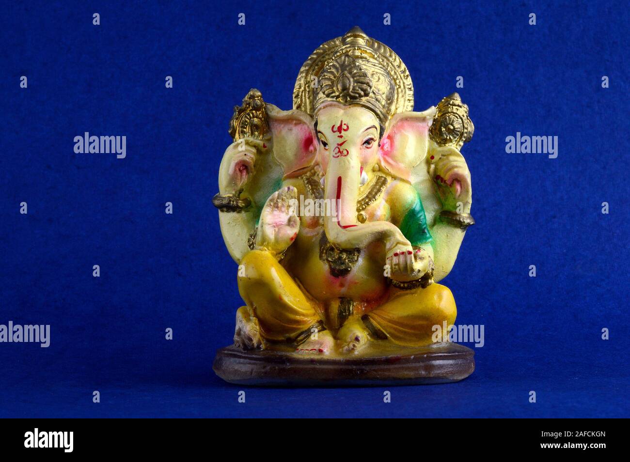Hindu God Ganesha. Ganesha Idol on Blue Background Stock Photo - Alamy