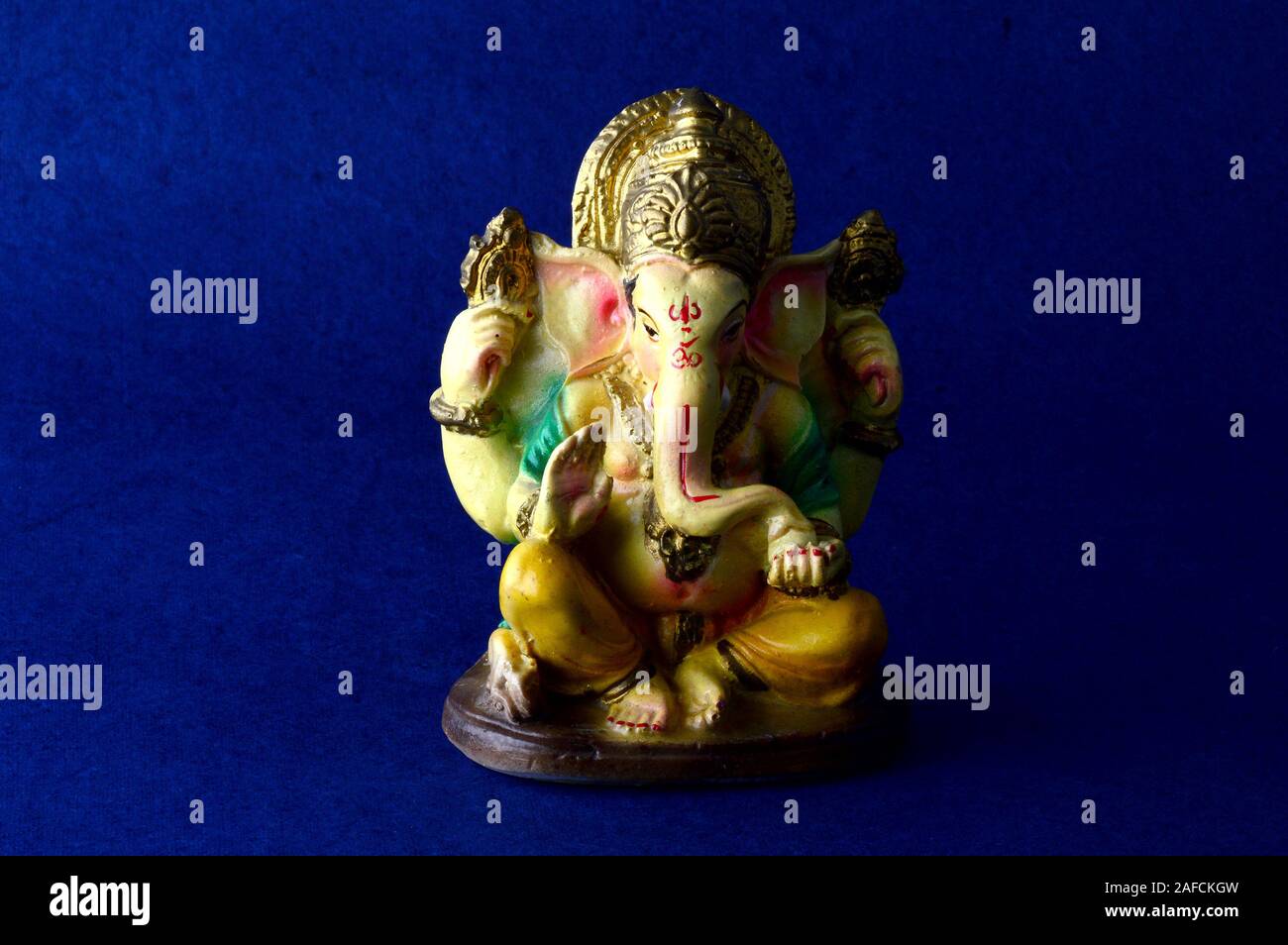 Hindu God Ganesha. Ganesha Idol on Blue Background Stock Photo - Alamy