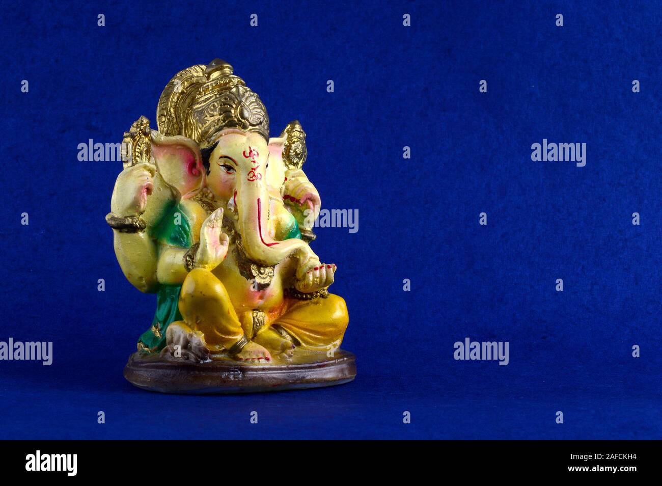 Hindu God Ganesha. Ganesha Idol on Blue Background Stock Photo - Alamy