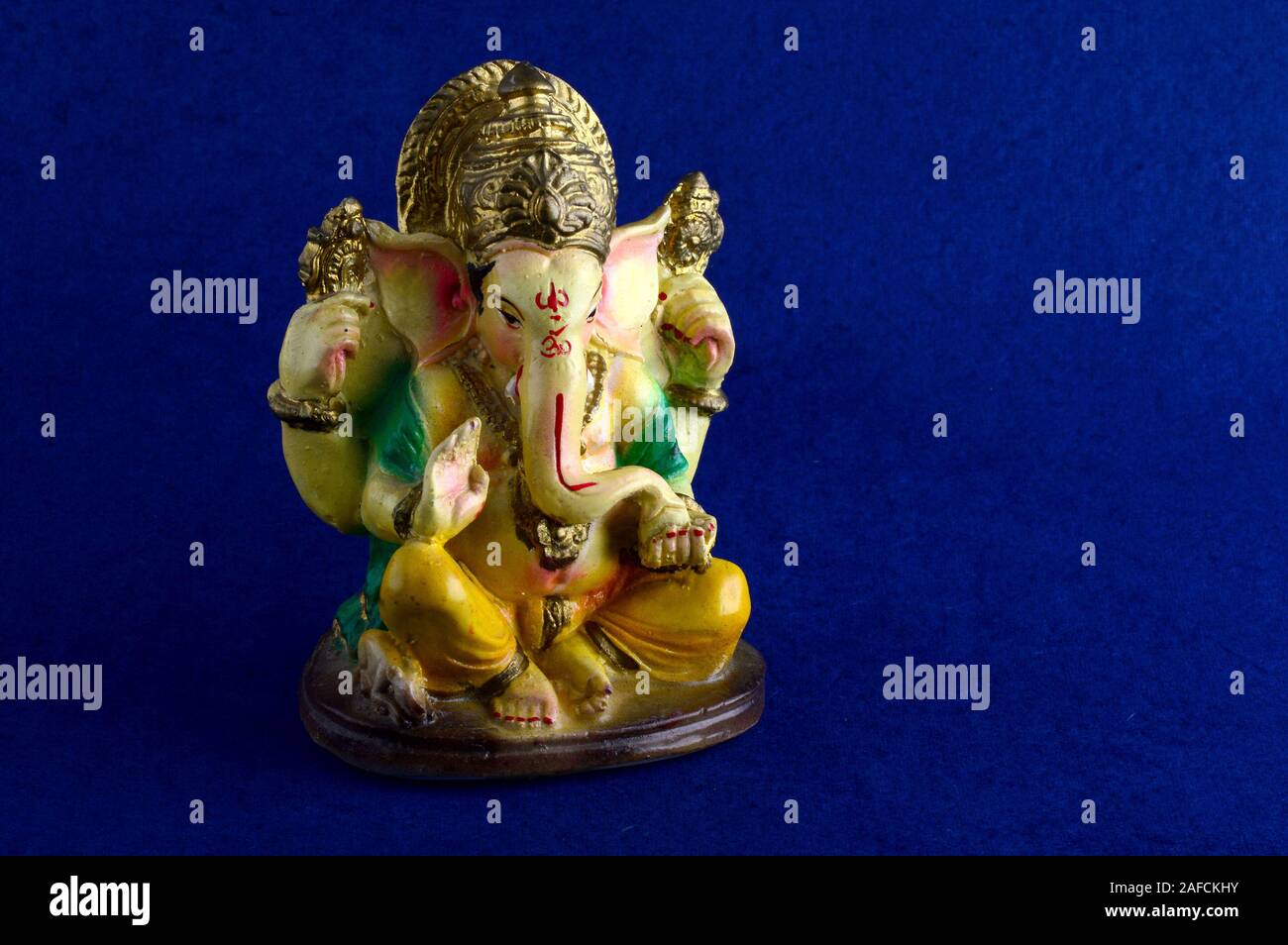 Hindu God Ganesha. Ganesha Idol on Blue Background Stock Photo - Alamy