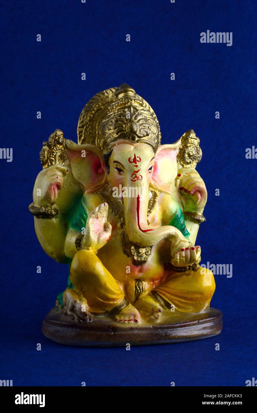 Hindu God Ganesha. Ganesha Idol on Blue Background Stock Photo - Alamy