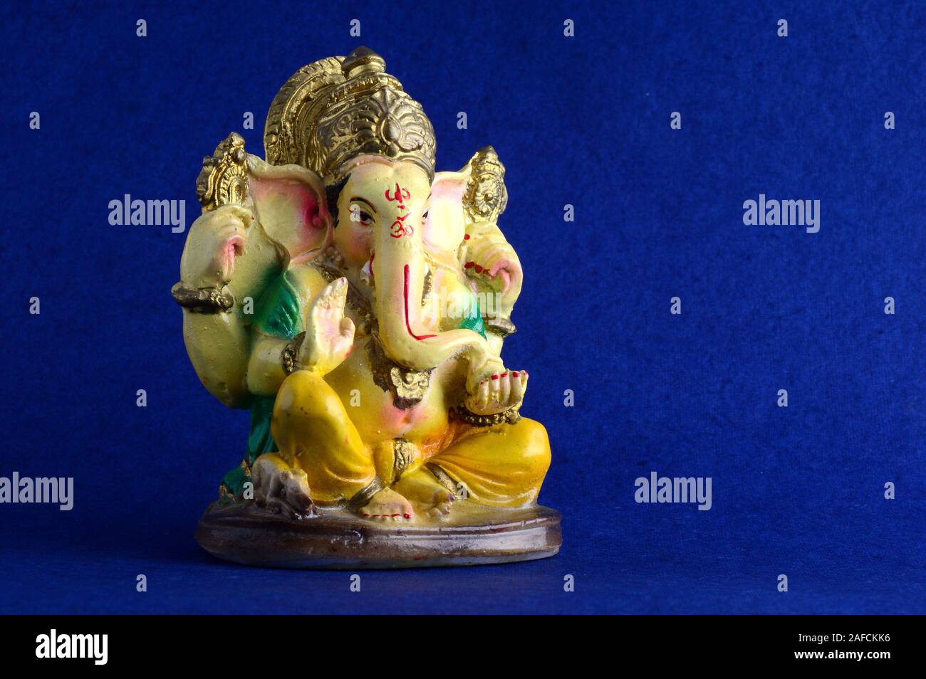 Hindu God Ganesha. Ganesha Idol on Blue Background Stock Photo - Alamy