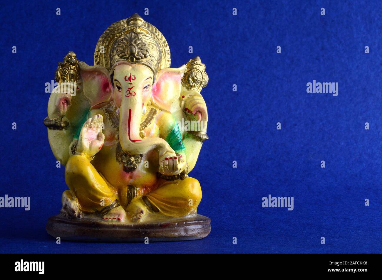 Hindu God Ganesha. Ganesha Idol on Blue Background Stock Photo - Alamy