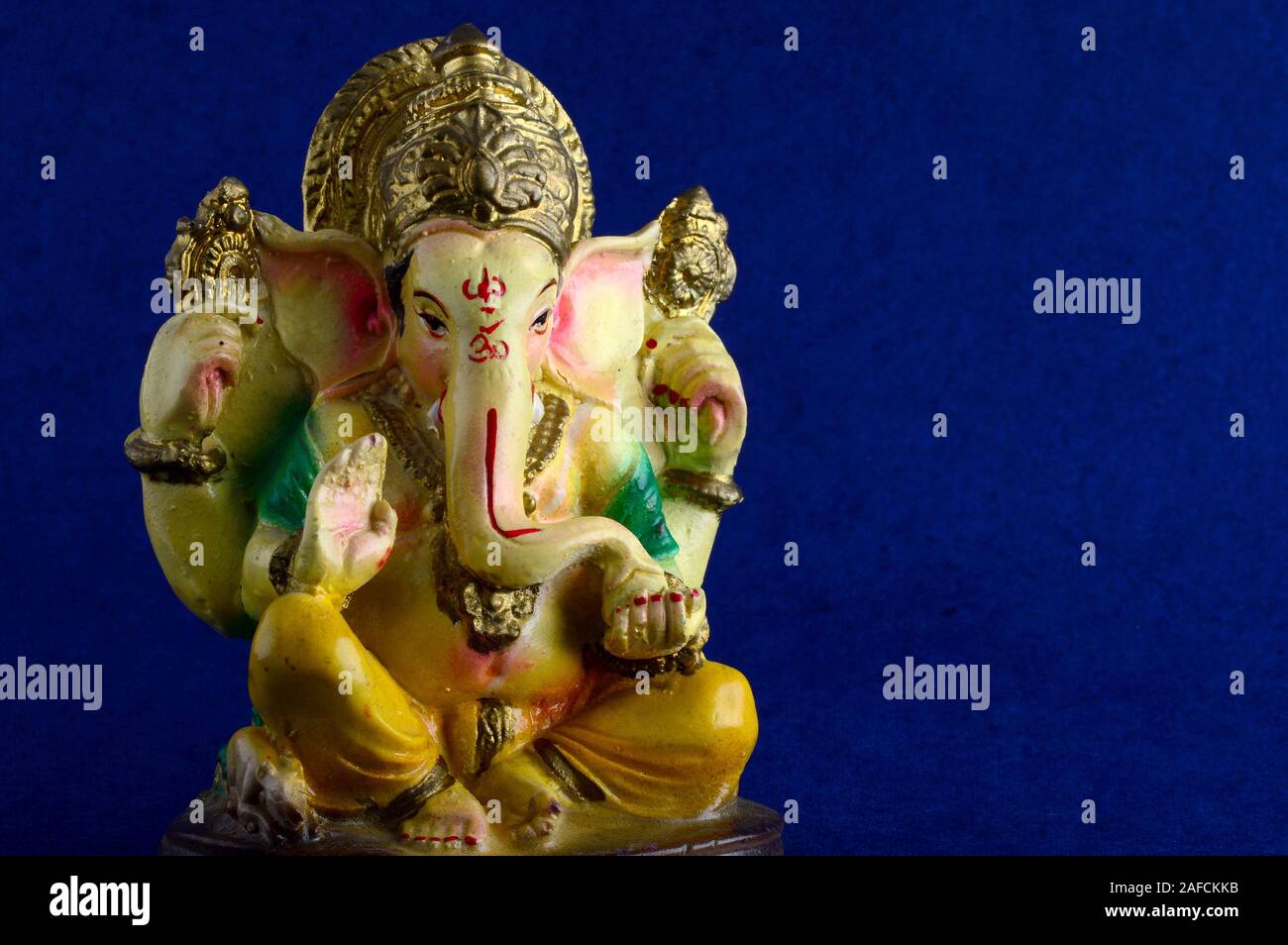 Hindu God Ganesha. Ganesha Idol on Blue Background Stock Photo - Alamy
