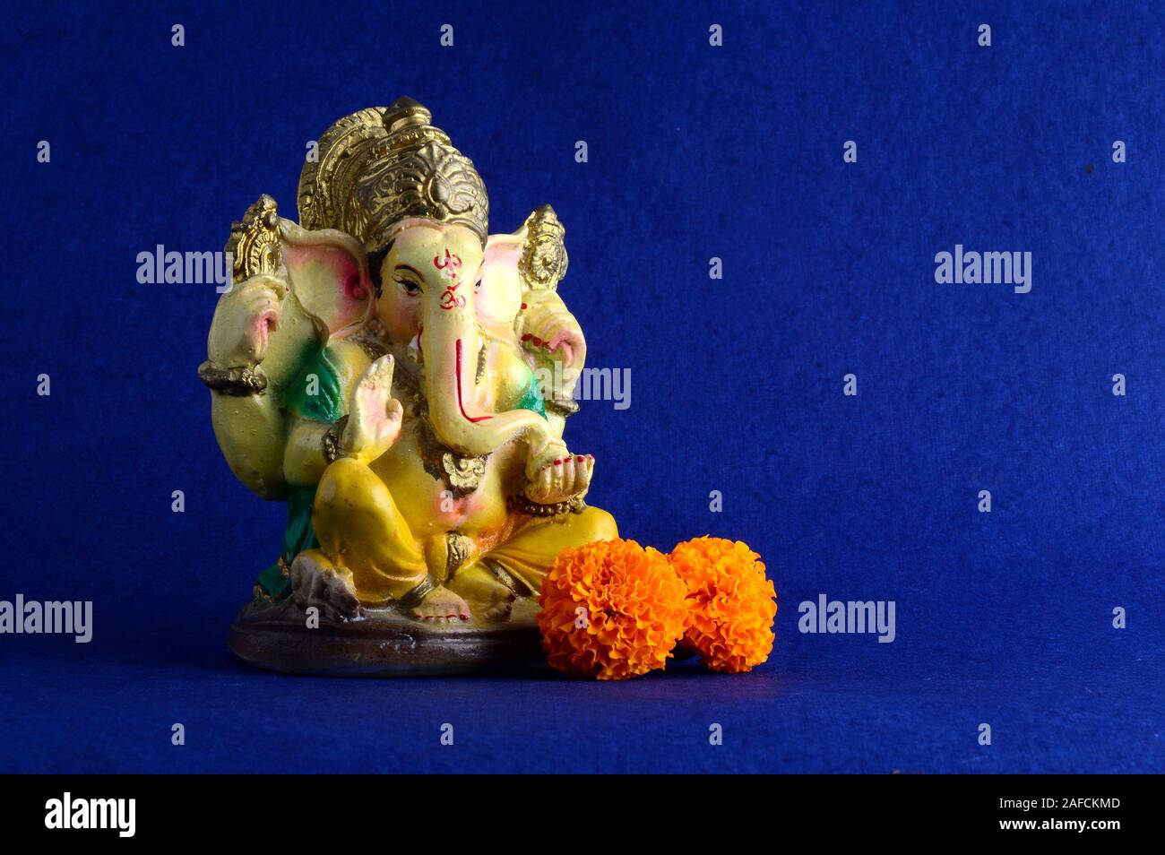 Hindu God Ganesha. Ganesha Idol on Blue Background Stock Photo - Alamy