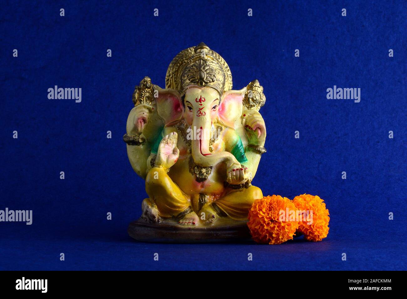 Hindu God Ganesha. Ganesha Idol on Blue Background Stock Photo - Alamy