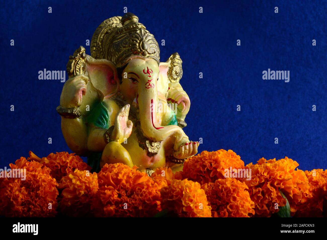 Hindu God Ganesha. Ganesha Idol on Blue Background Stock Photo - Alamy