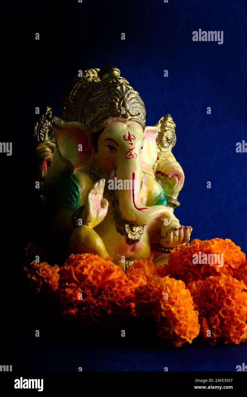 Hindu God Ganesha. Ganesha Idol on Blue Background Stock Photo - Alamy