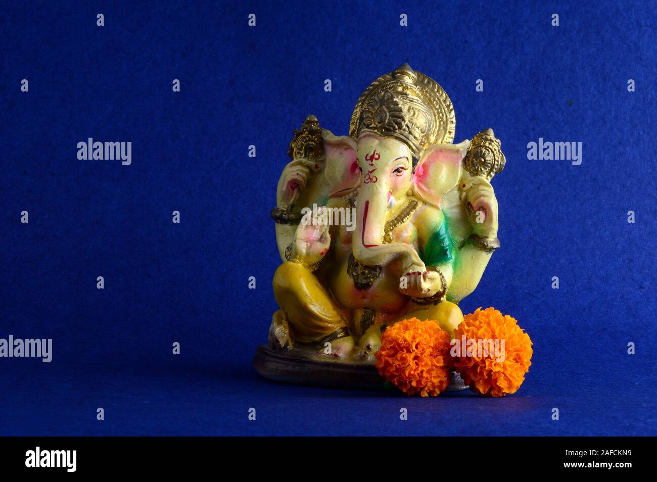Hindu God Ganesha. Ganesha Idol on Blue Background Stock Photo - Alamy